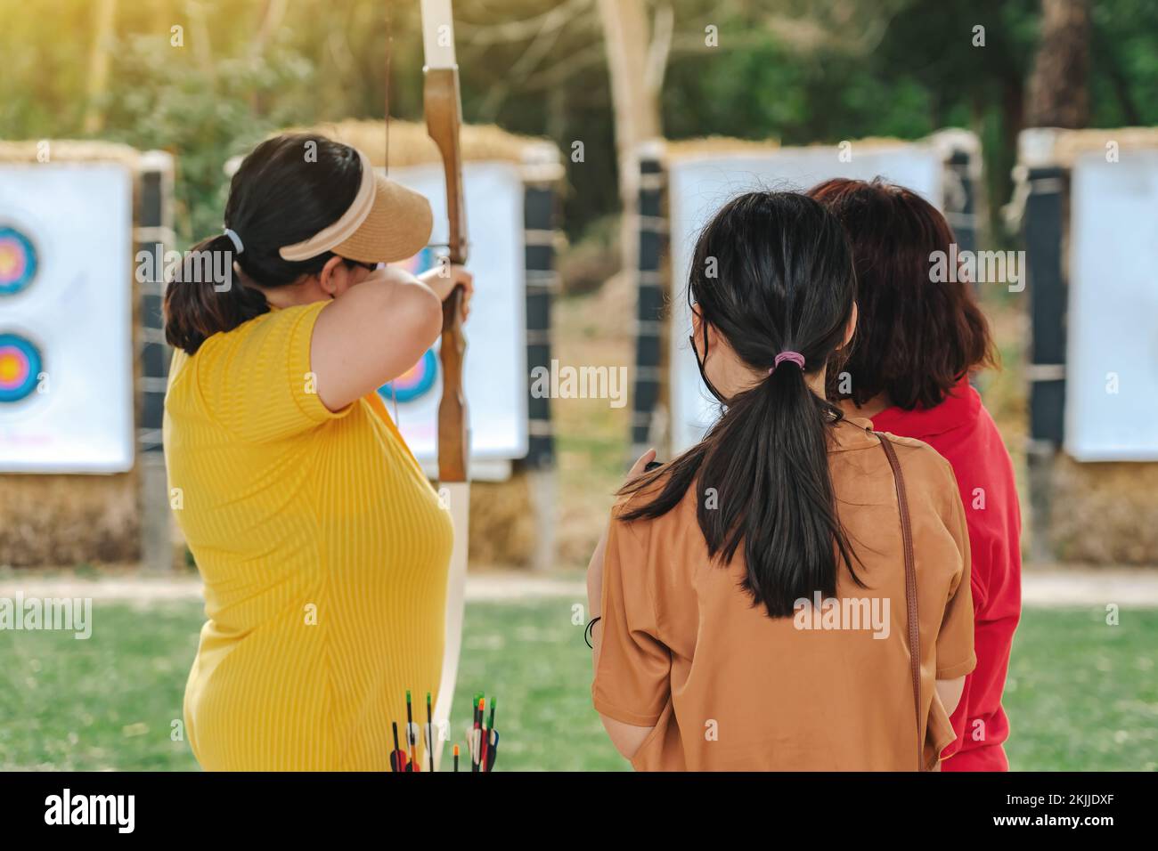Back view of daughter wear face mask cheering and taking pictures for ...