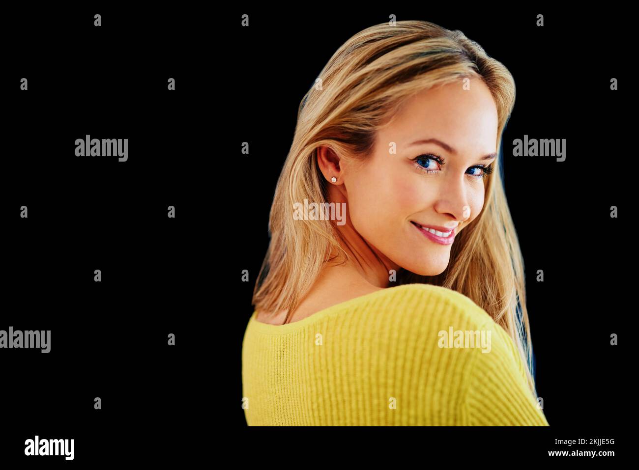 Giving you a coy smile. Studio portrait of a beautiful young blonde ...