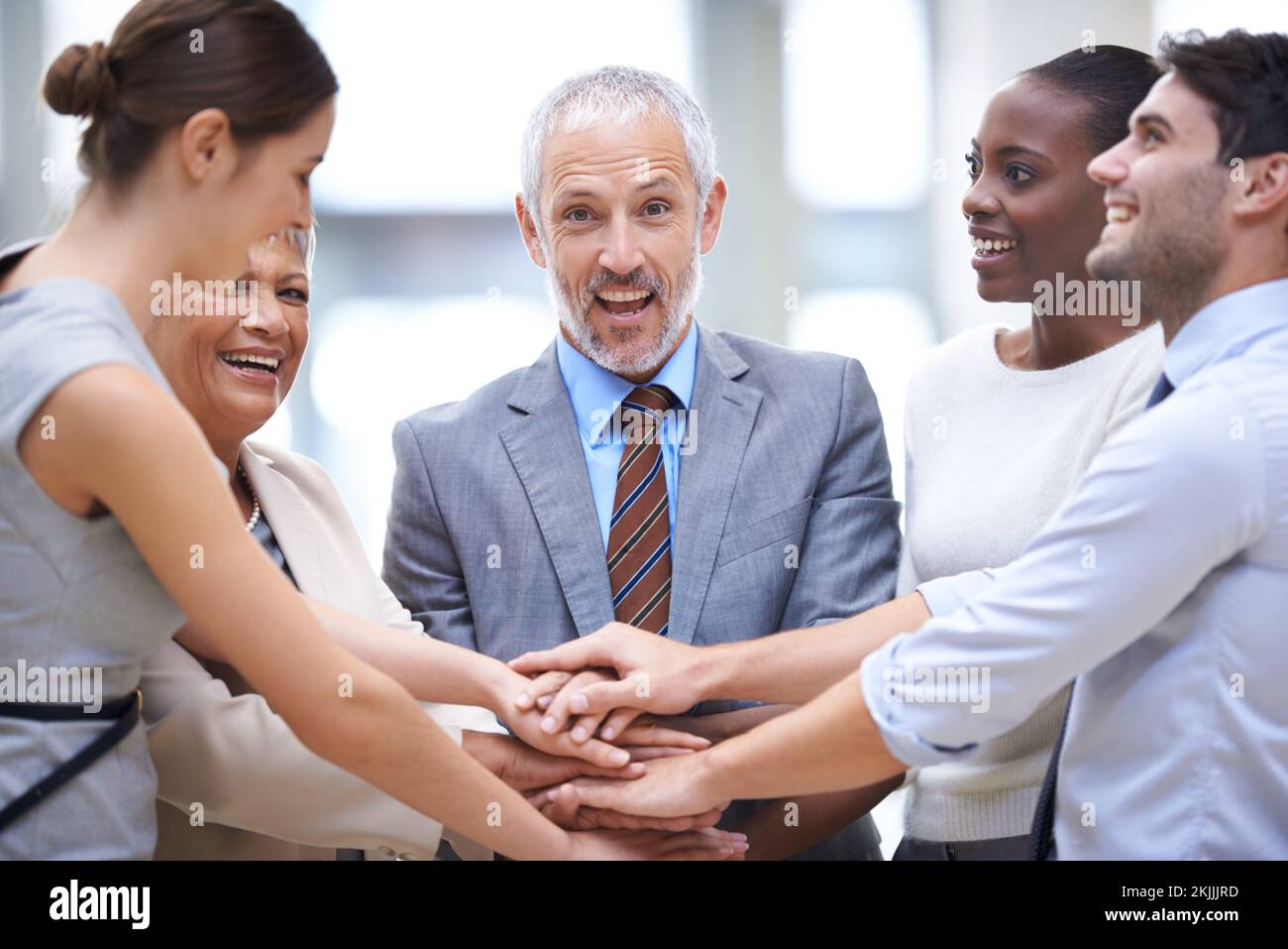 Excited to start their team venture. a group of businesspeople putting ...