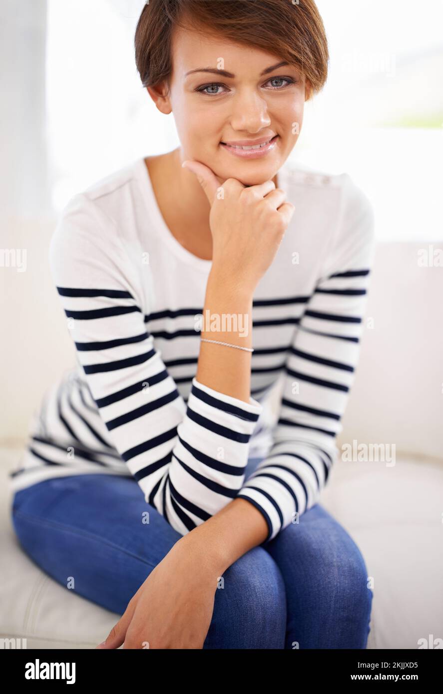 Super stunner in stripes. an attractive young woman relaxing at home ...