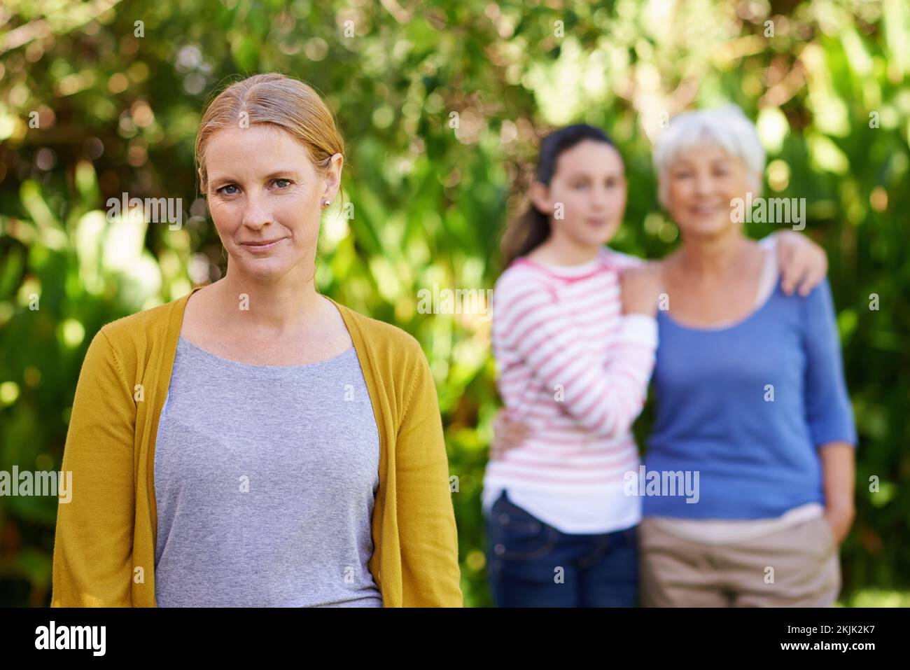 Strong family bonds. three generations of family women standing ...