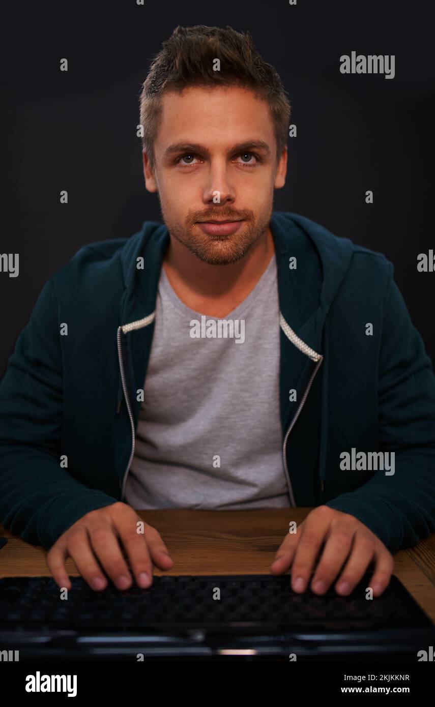 Working on a new game. a young programmer focused on his work Stock ...