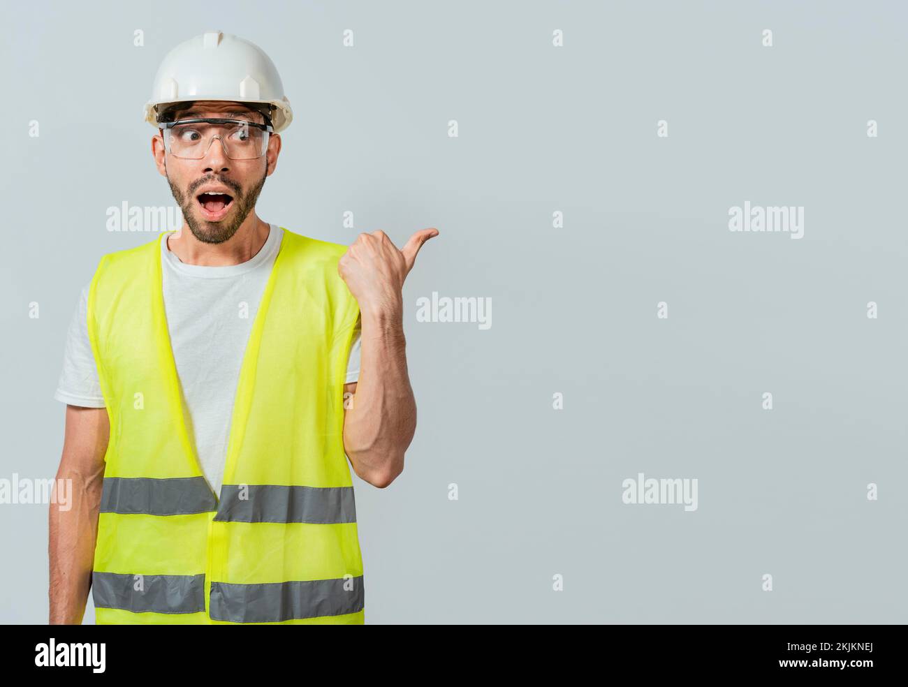 Surprised engineer pointing to the side. Surprised face construction ...