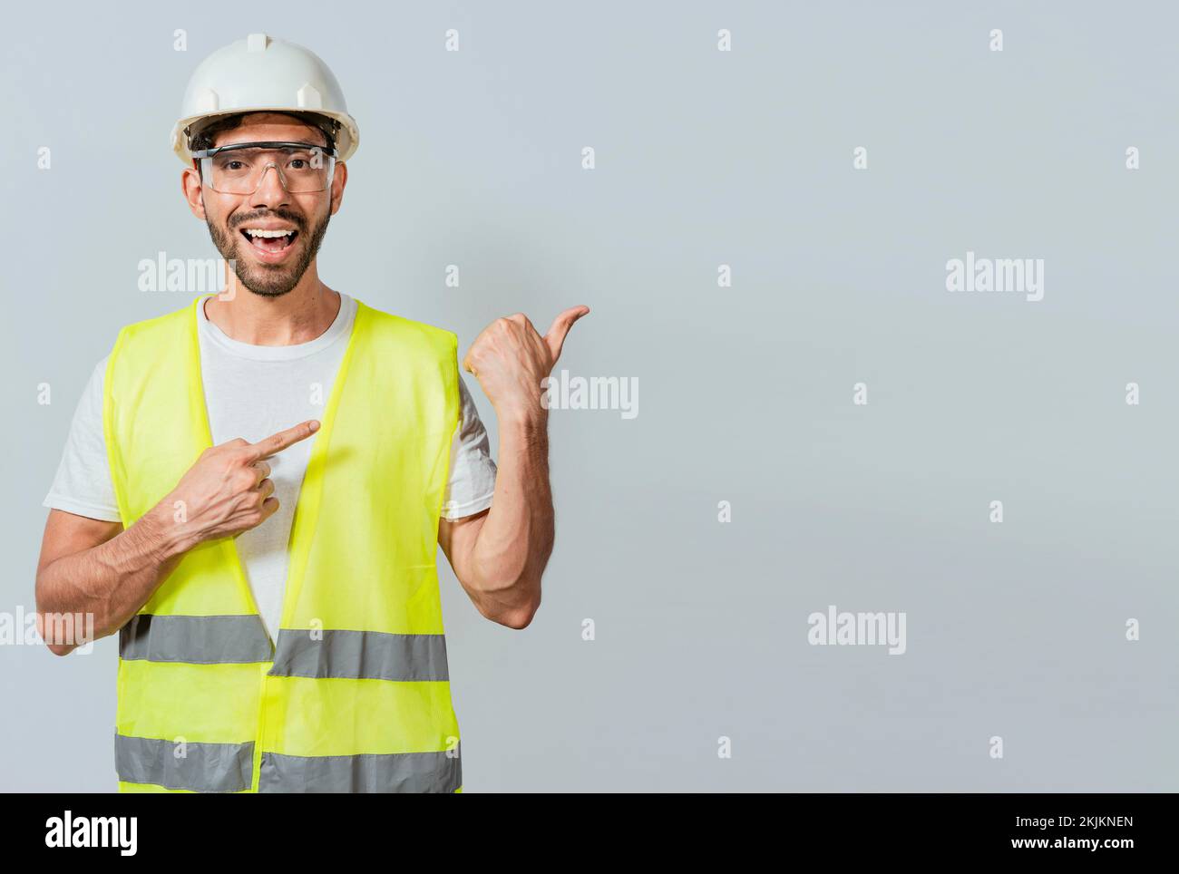Construction engineer with vest pointing at an advertisement. Engineer ...