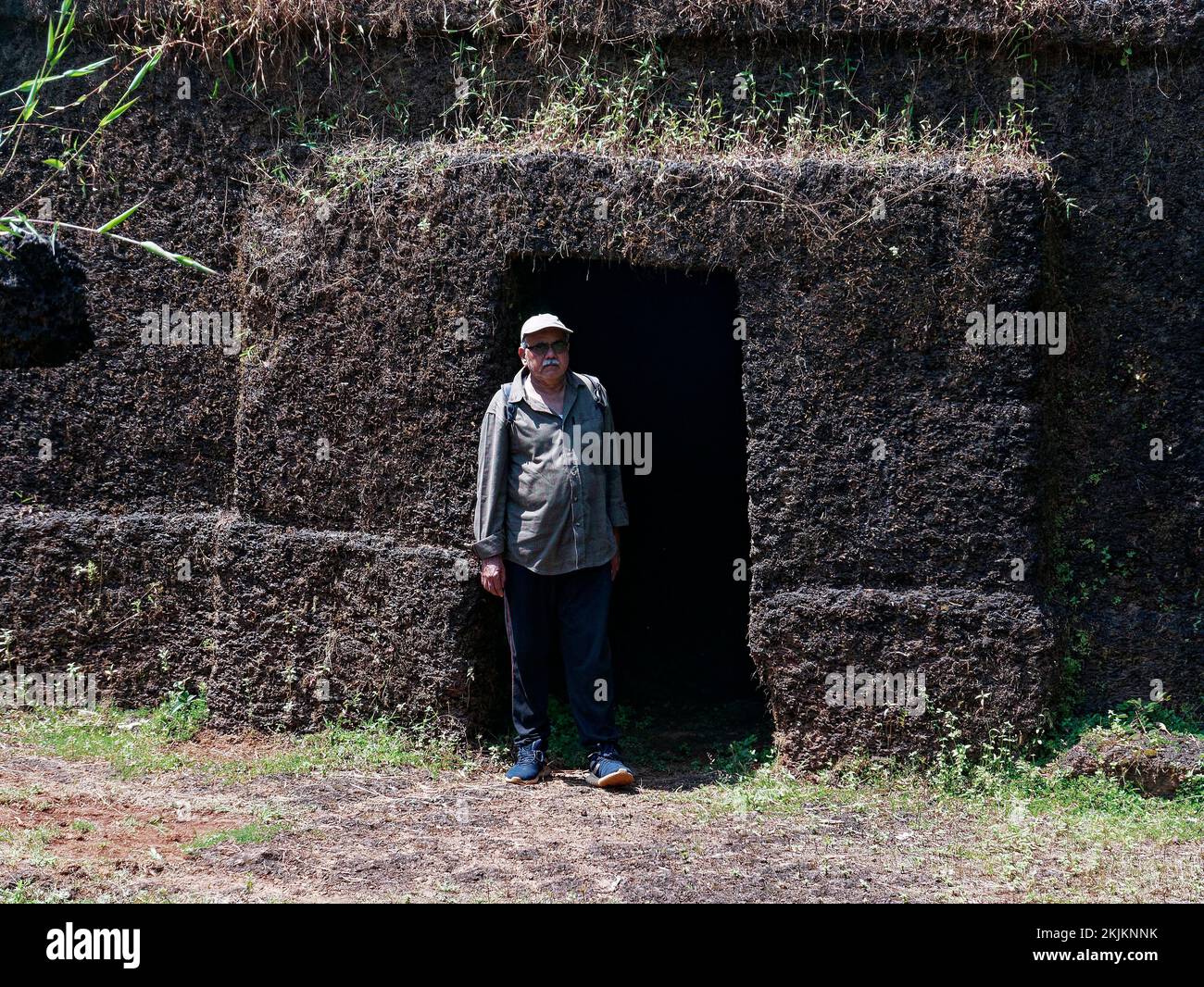 Tourist visiting Caves at Khandepar monolithic laterite cut cave temple ...