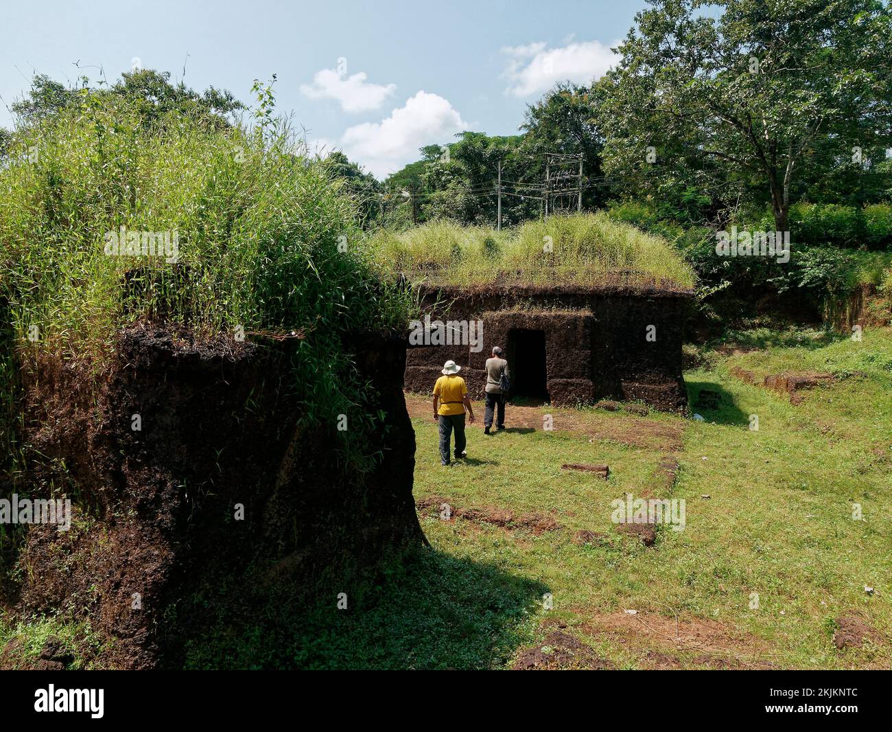 Tourist visiting Caves at Khandepar monolithic laterite cut cave temple ...