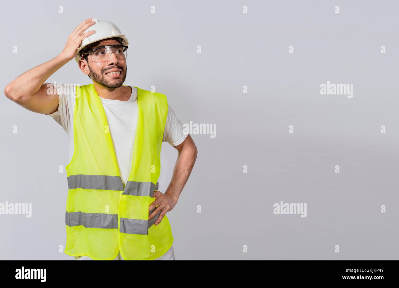Worried builder engineer holding his head. Worried engineer man looking ...