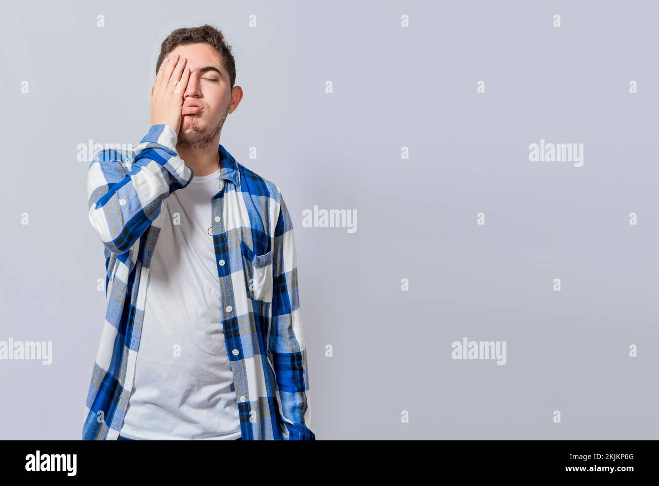 Exhausted person putting the palm of his hand on his face. Tired and ...