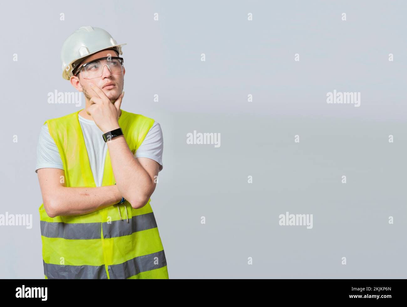Concept of a meditative engineer solated. Pensive builder man with hand ...
