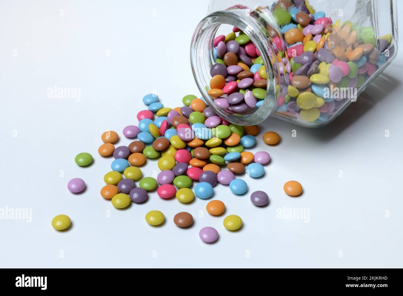 Chocolate lentils with glass container, Smarties Stock Photo - Alamy