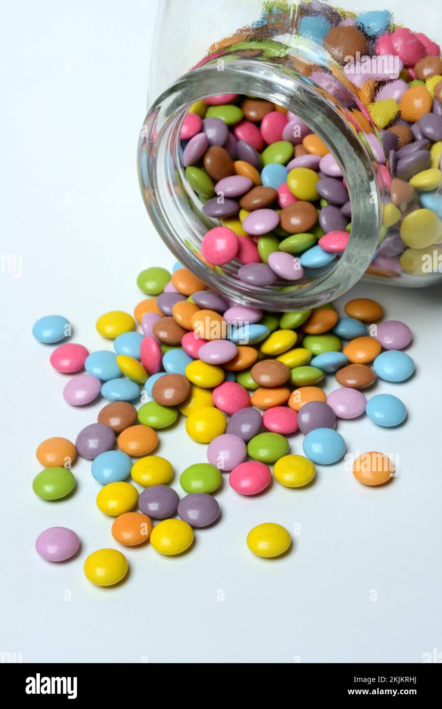 Chocolate lentils with glass container, Smarties Stock Photo - Alamy
