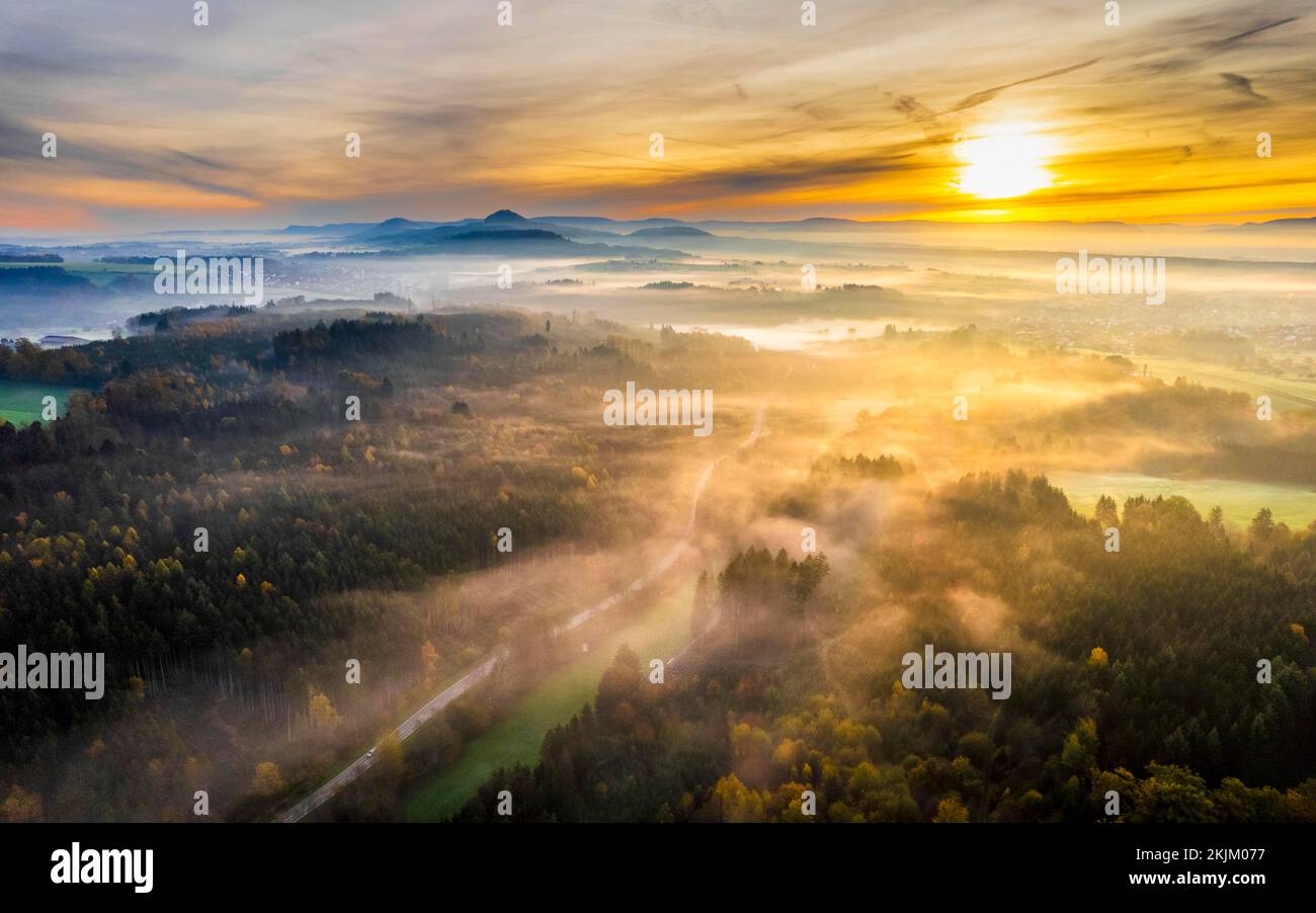 Drone view of sunrise over forest and rural landscape in autumn, region ...