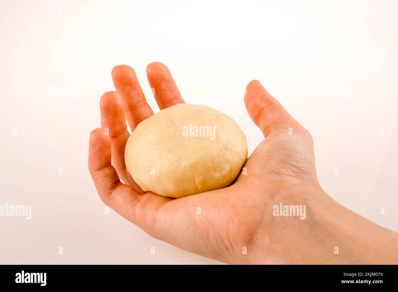 Hand holding paste on a white background Stock Photo - Alamy
