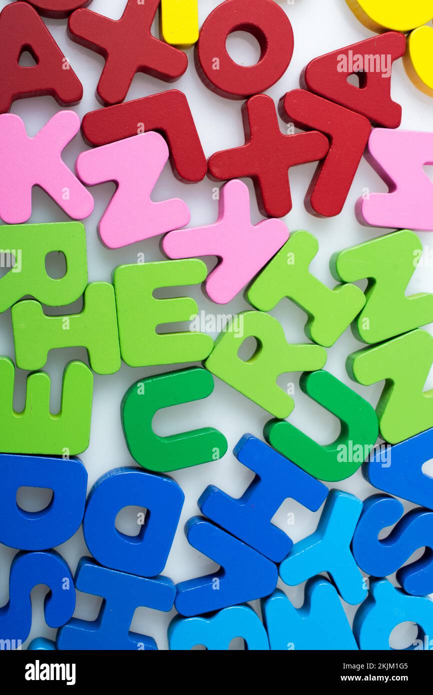Colorful alphabet letter blocks scattered randomly on white background ...