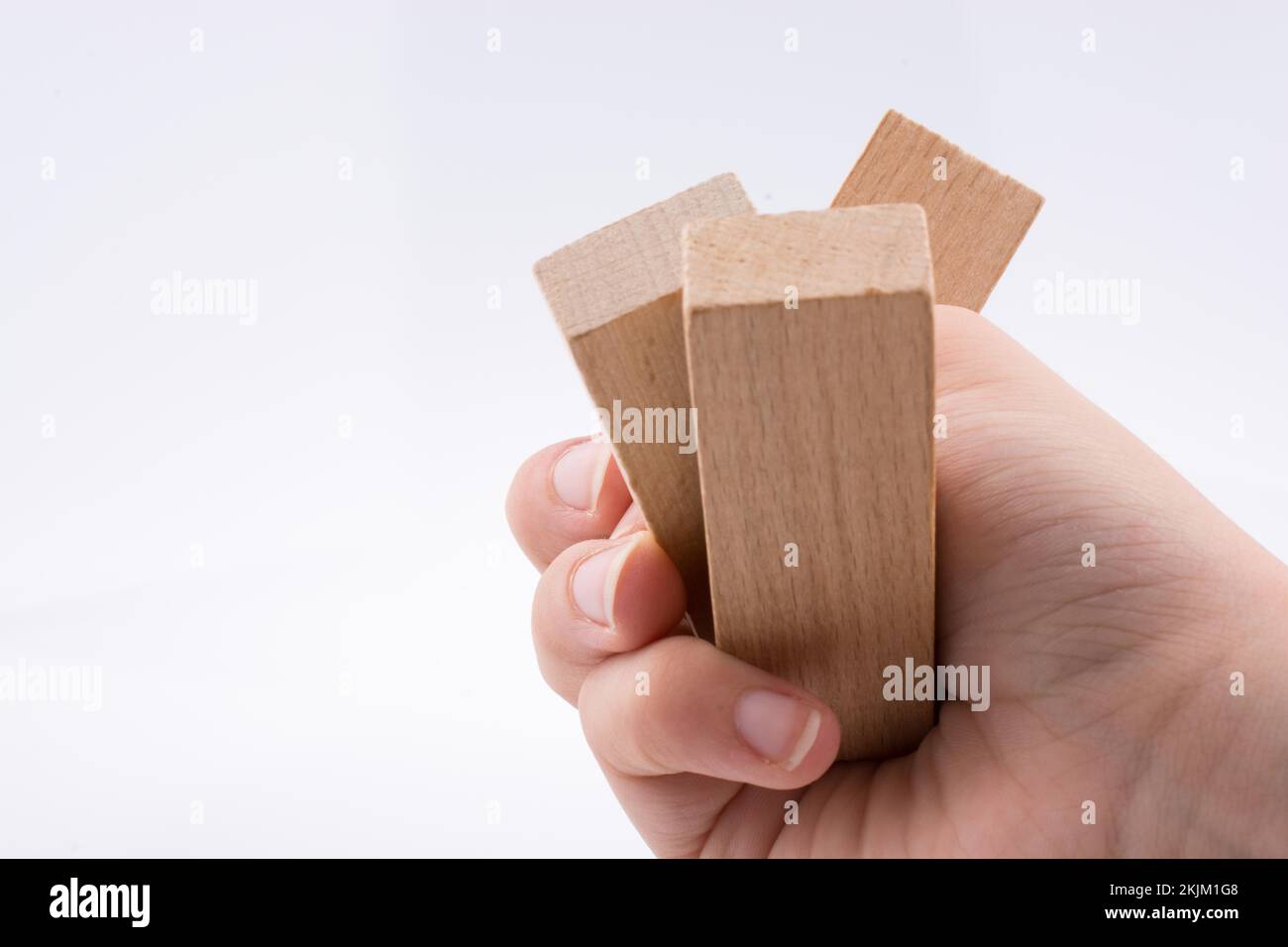 Hand playing with wooden building blocks on white background Stock ...