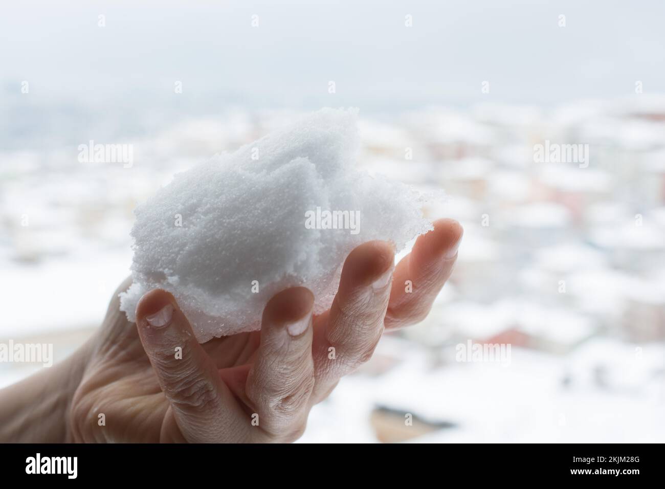 Snow in hand hand with winter related background Stock Photo - Alamy