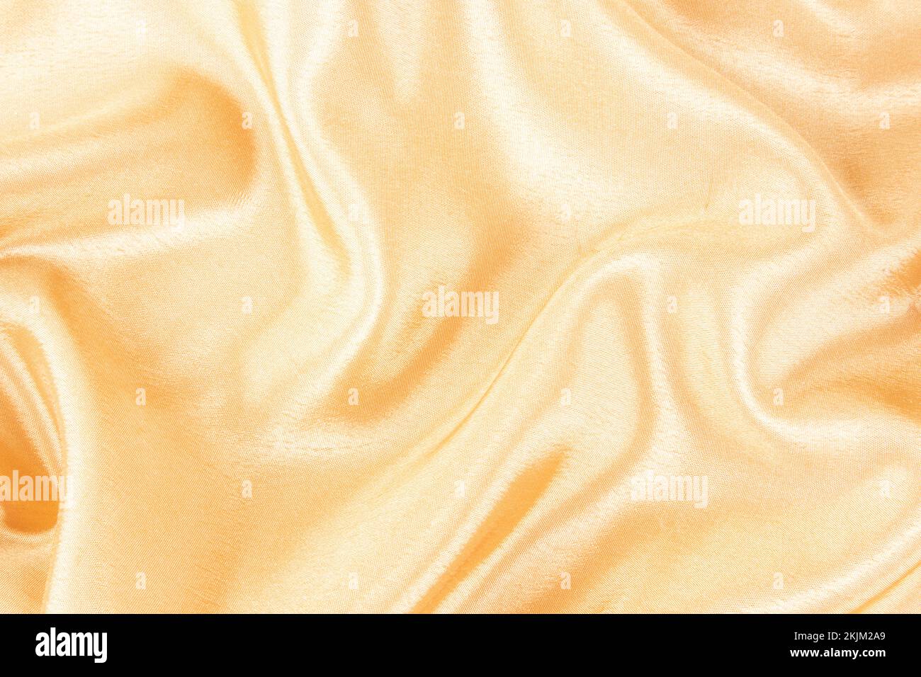 Smooth elegant gold color silk or satin luxury cloth texture can use as ...