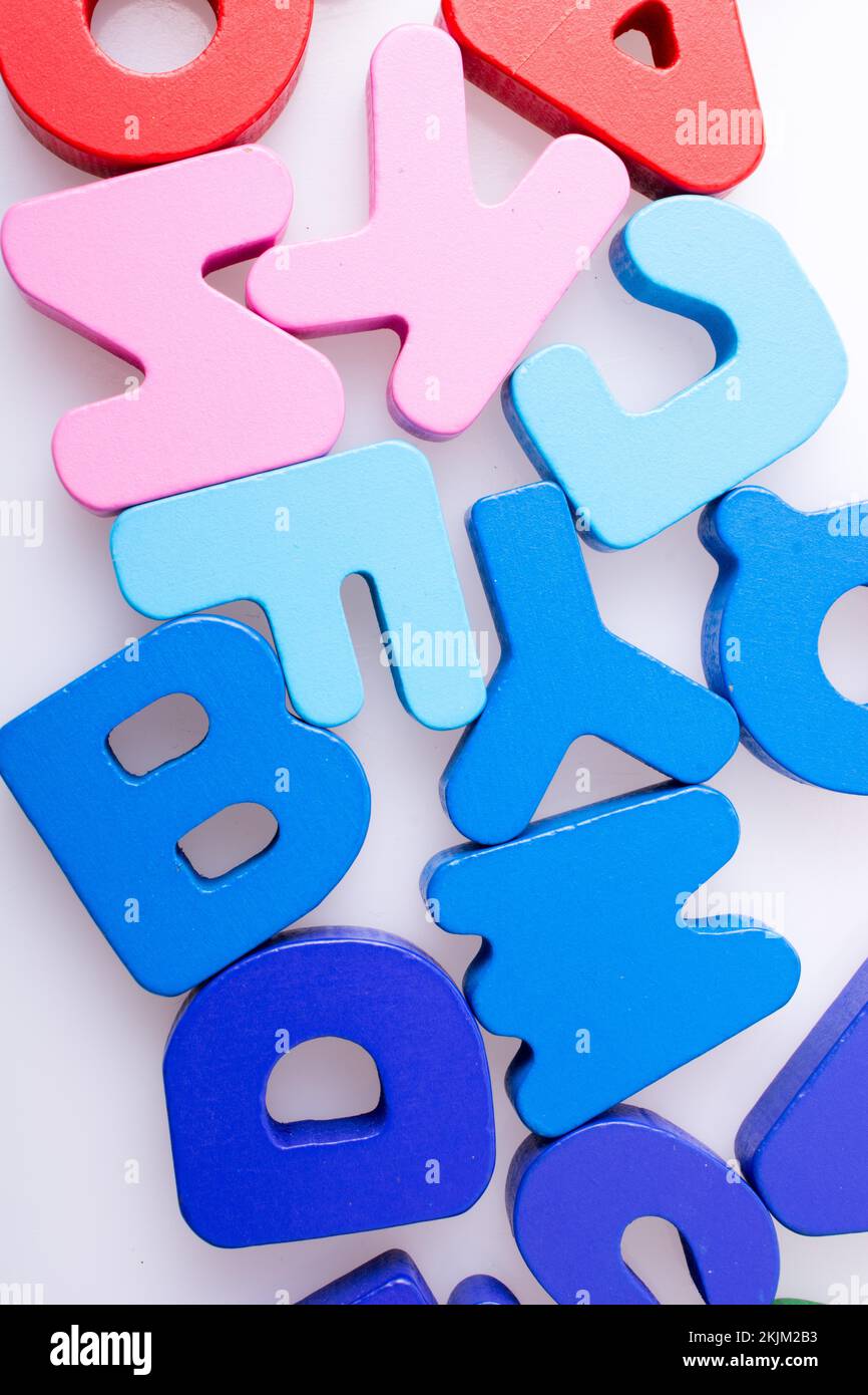 Colorful alphabet letter blocks scattered randomly on white background ...