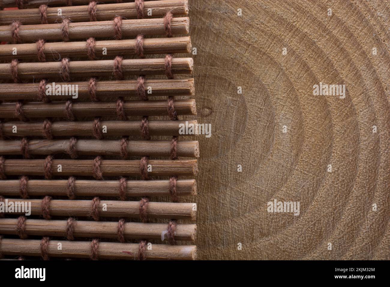 Wood log cut in round thin pieces and a brown color straw carpet Stock ...