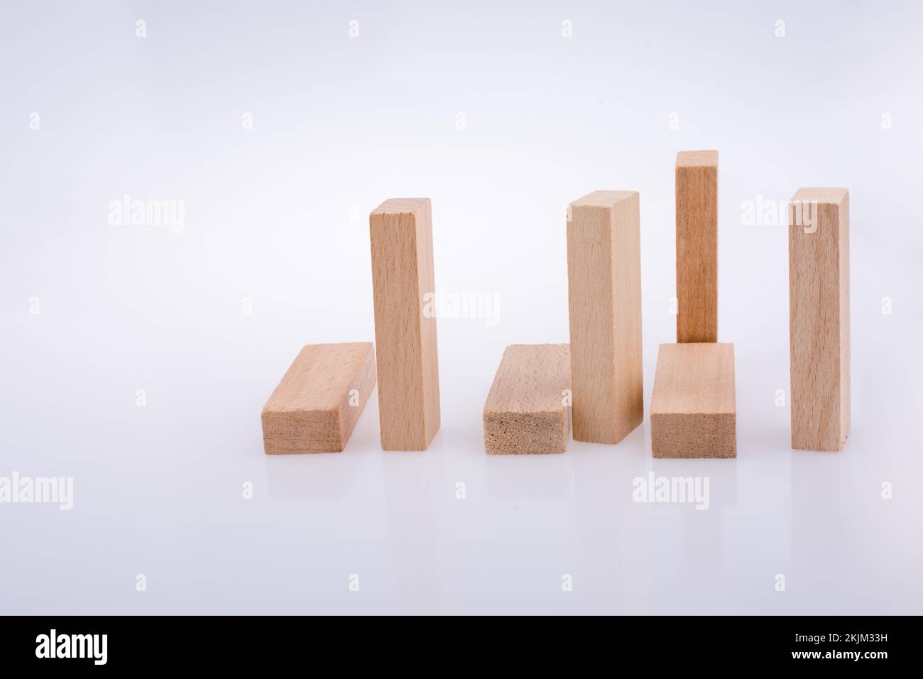 Wooden domino pieces positioned on white background Stock Photo - Alamy