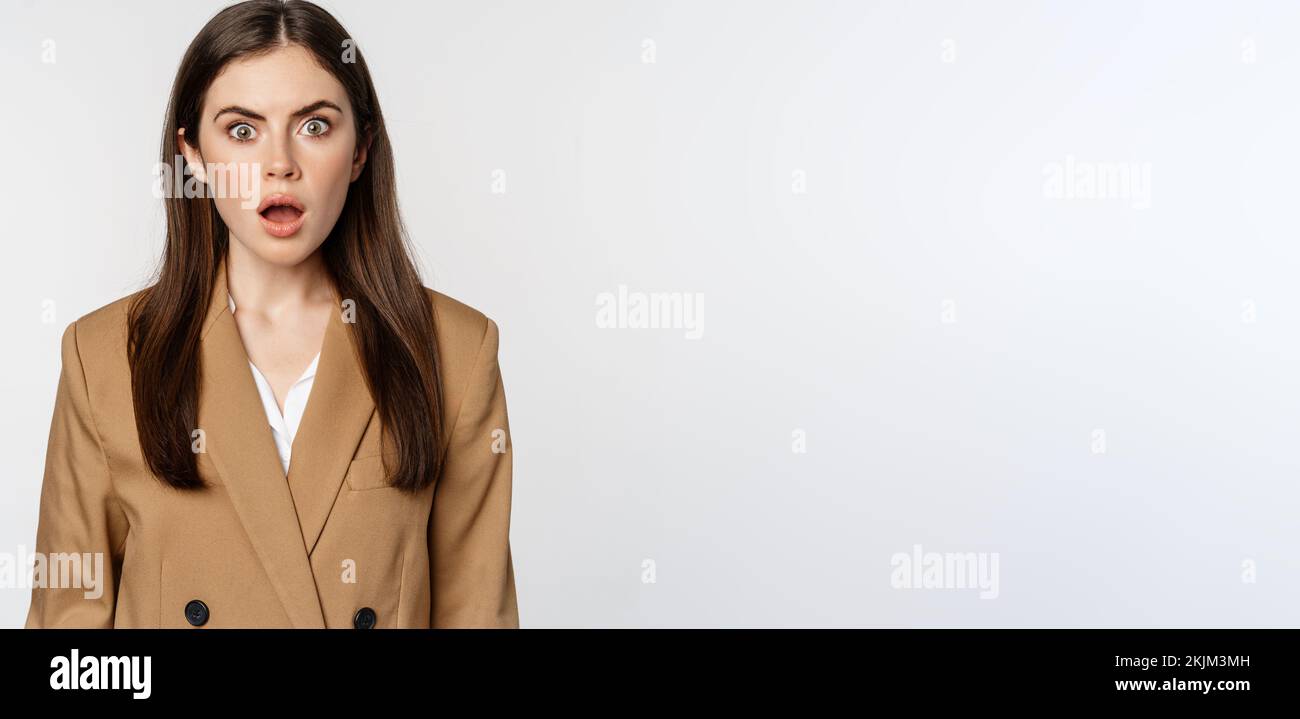 Portrait of shocked, speechless businesswoman gasping, staring stunned ...