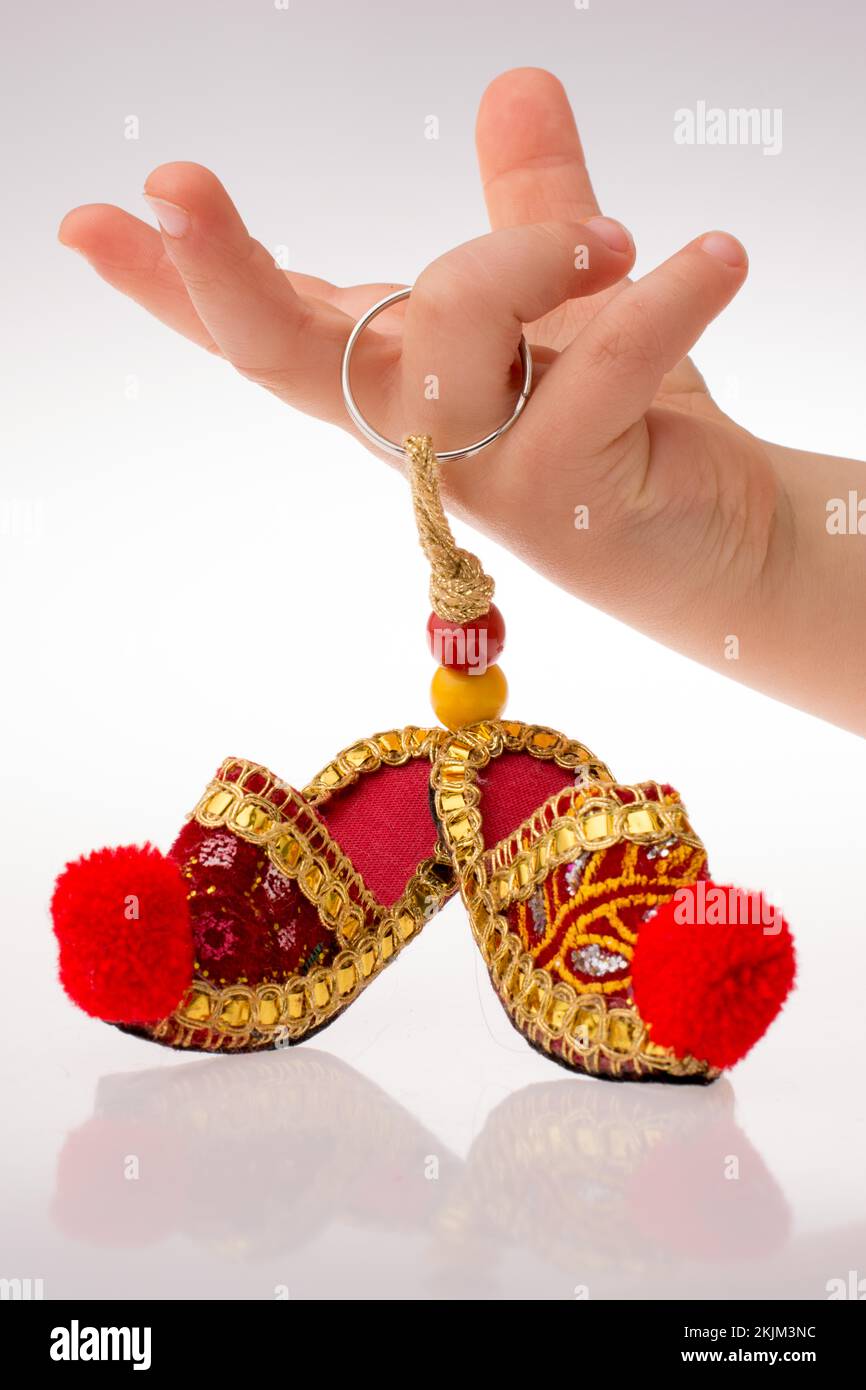 Traditional slippers in hand on white background Stock Photo - Alamy