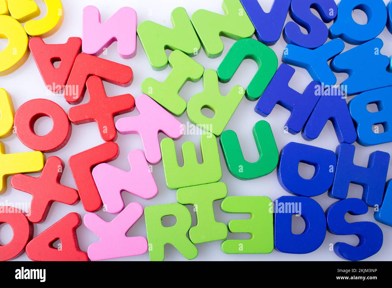 Colorful alphabet letter blocks scattered randomly on white background ...