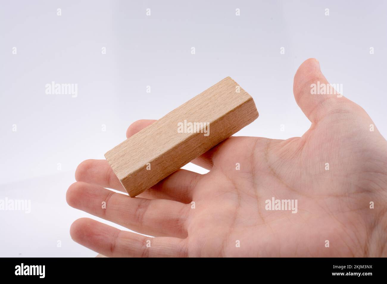 Hand playing with wooden building blocks on white background Stock ...