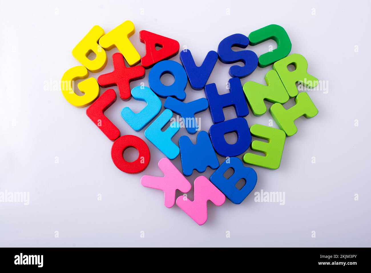 Colorful letter blocks shape heart on white background Stock Photo - Alamy