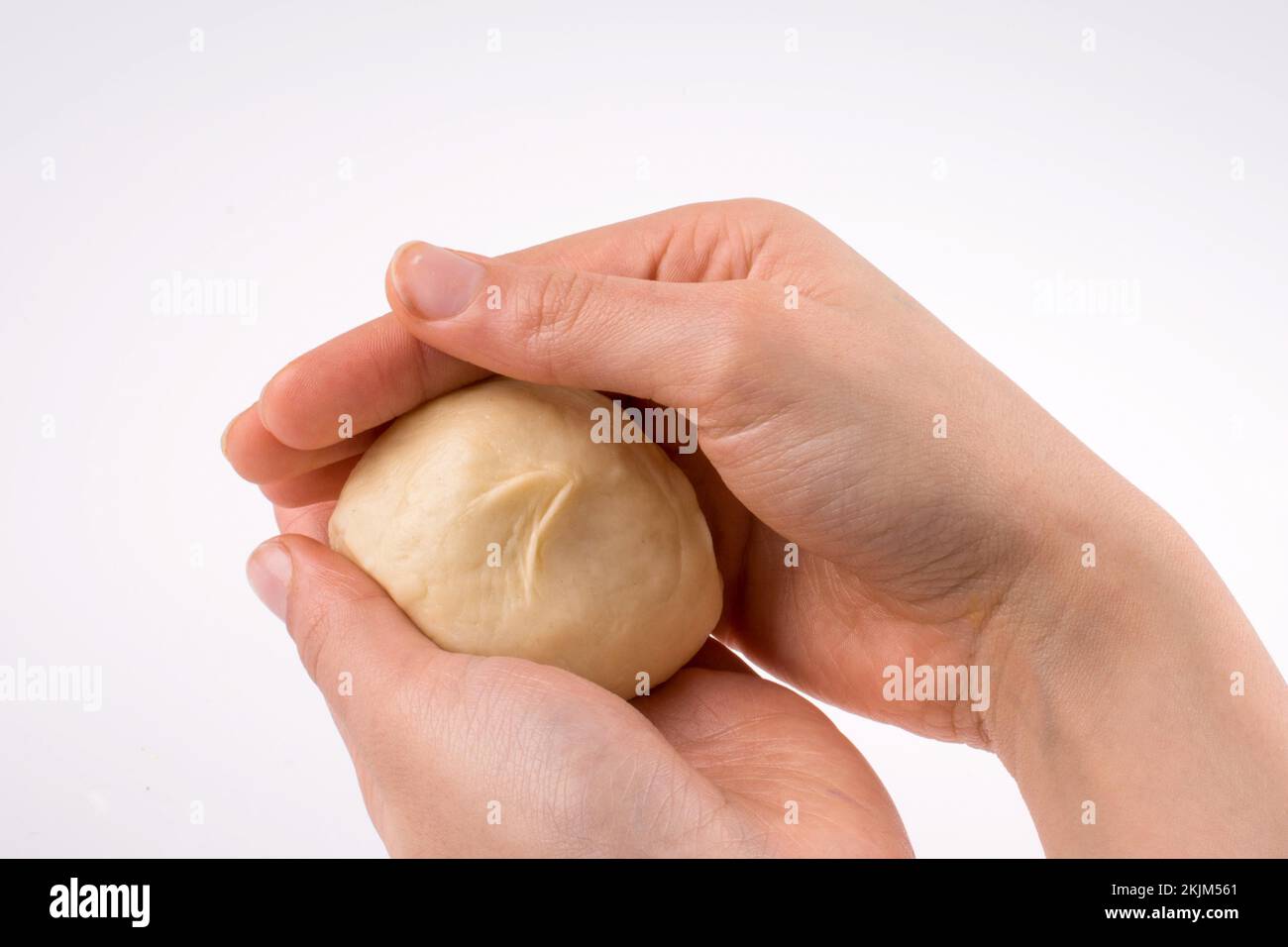 Hand holding paste on a white background Stock Photo - Alamy