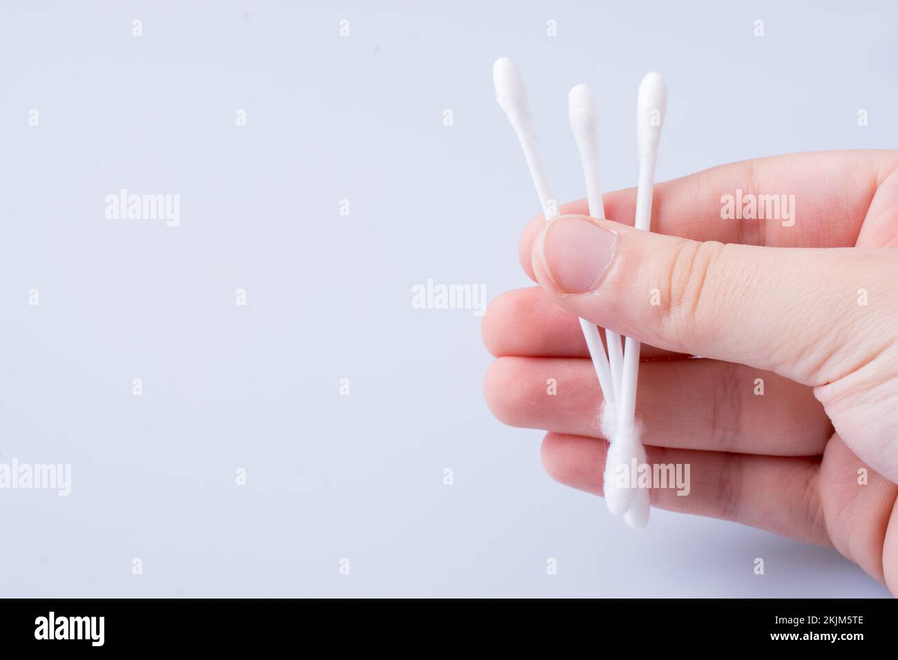 A few ear sticks in hand isolated on white background Stock Photo - Alamy