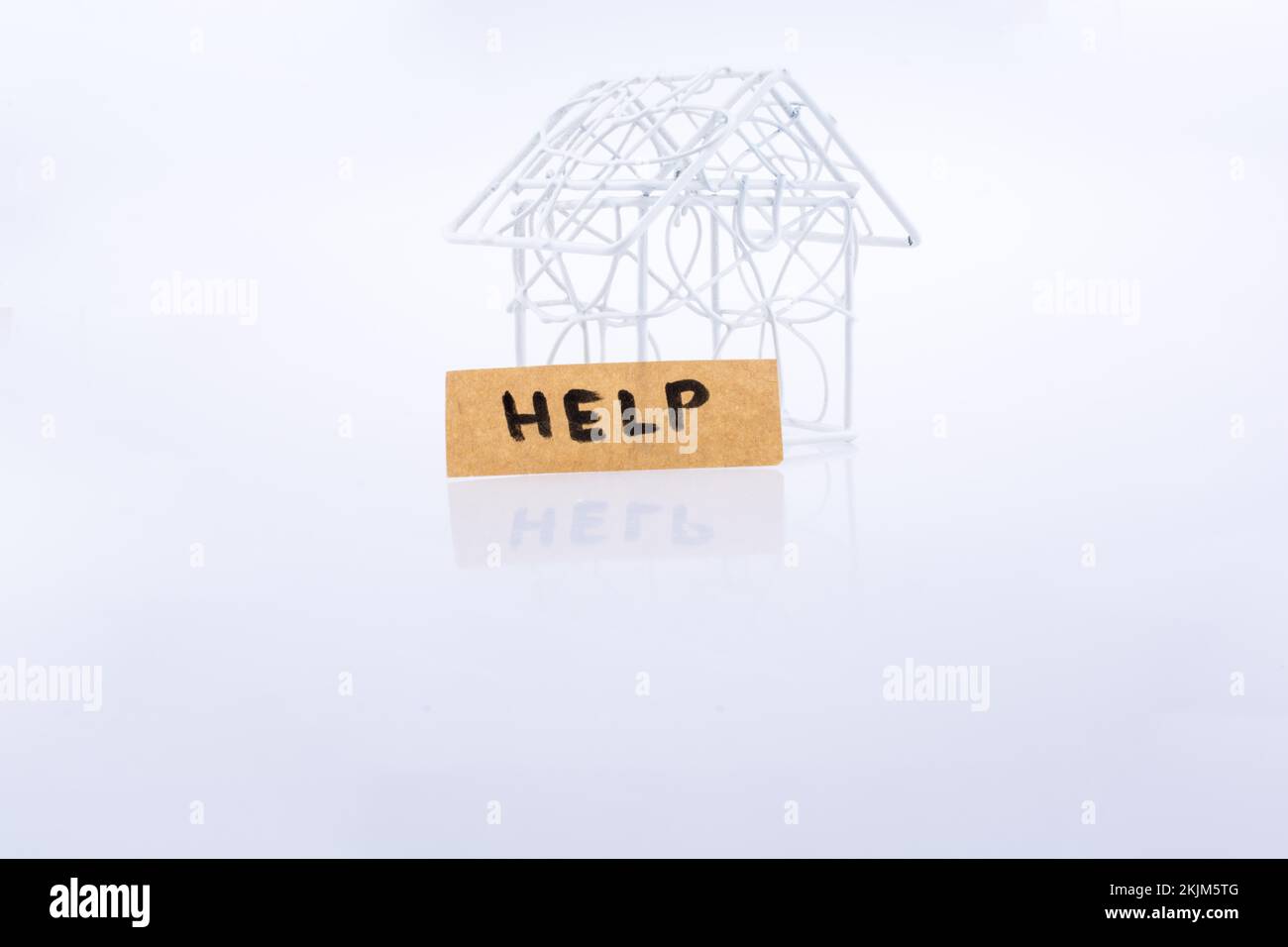 Little metal house and the word HELP on a white background Stock Photo ...