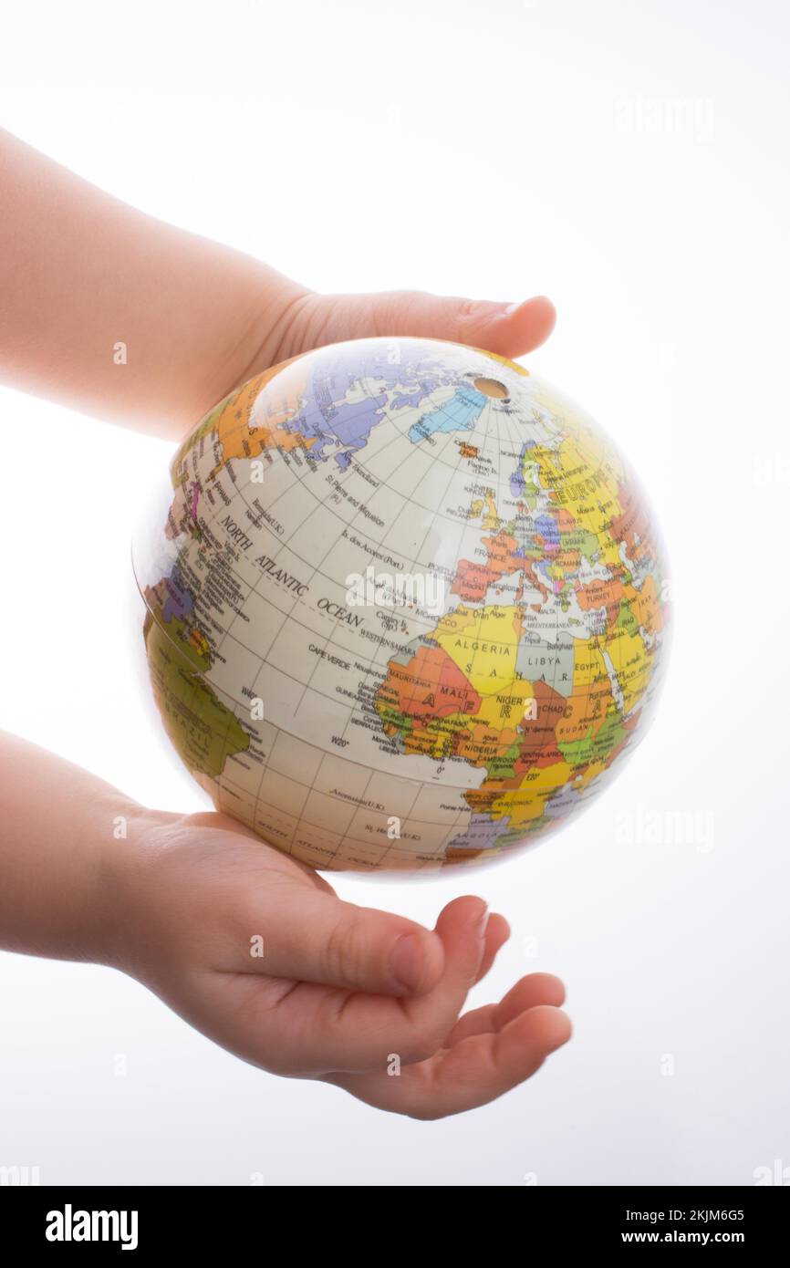 Child holding a globe in on a white background Stock Photo - Alamy