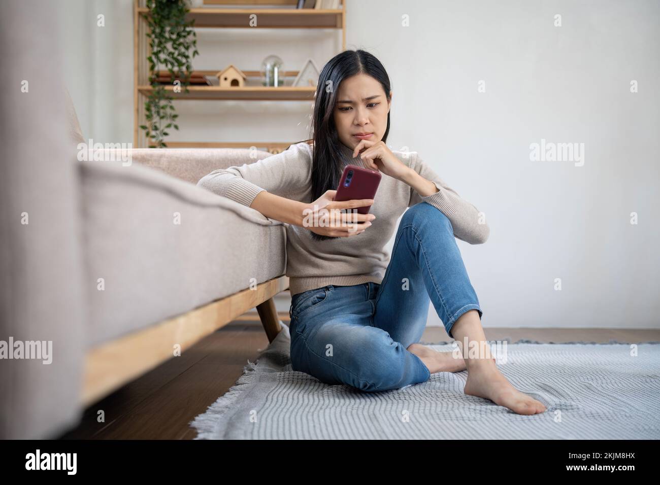 Portrait of beautiful young woman with depressed facial expression ...