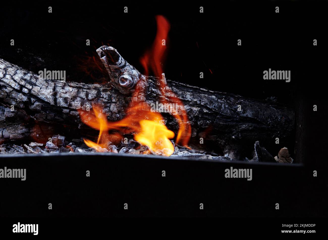 Burning red hot sparks fly from fire. Barbecue gril with glowing and ...