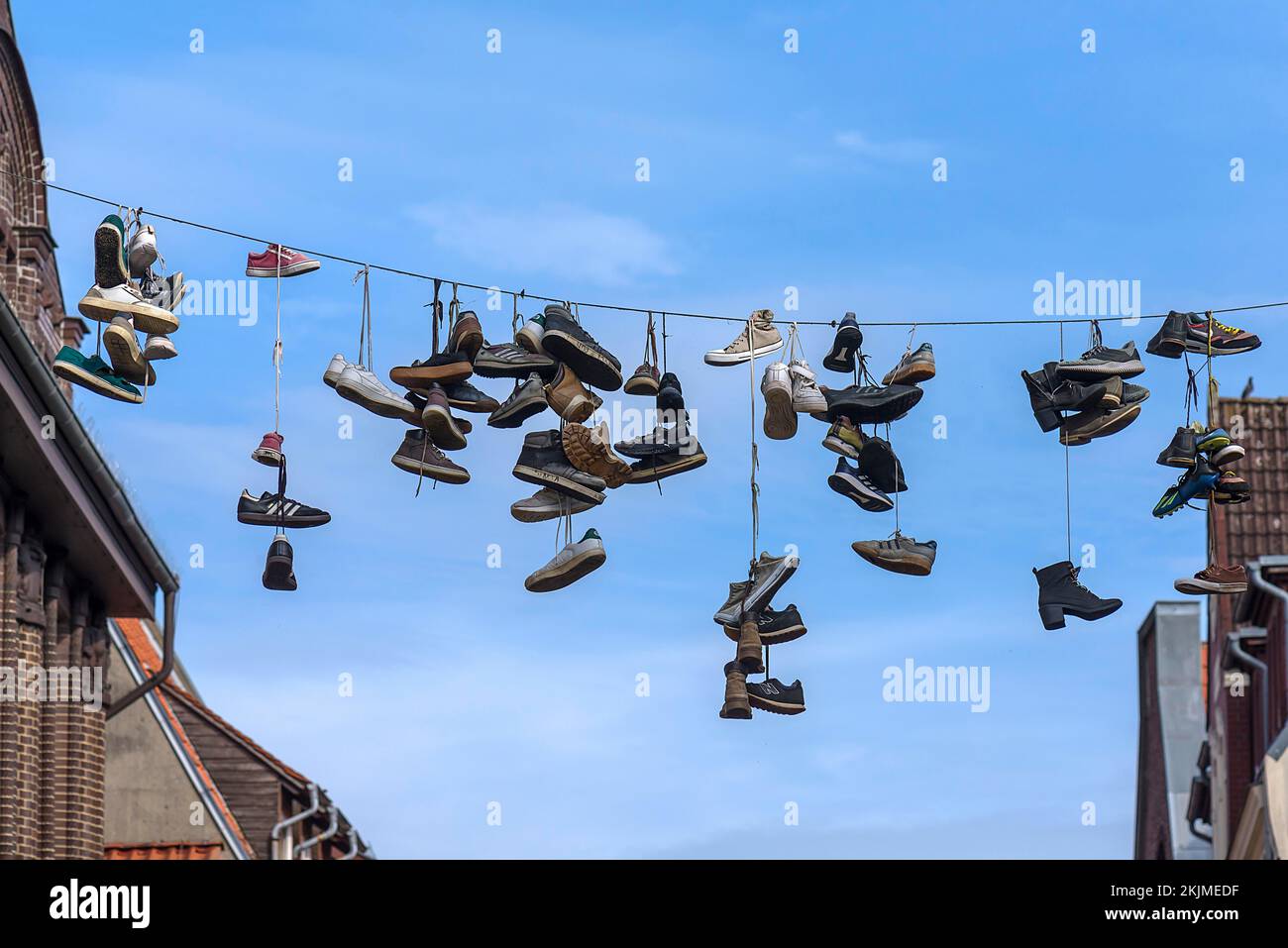 New street art Shoefiti, trainers hanging on a leash in the pedestrian ...