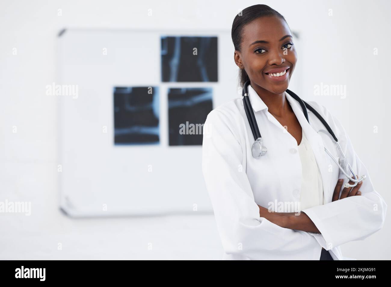 Shes a successful radiologist. a female doctor standing in front of a ...