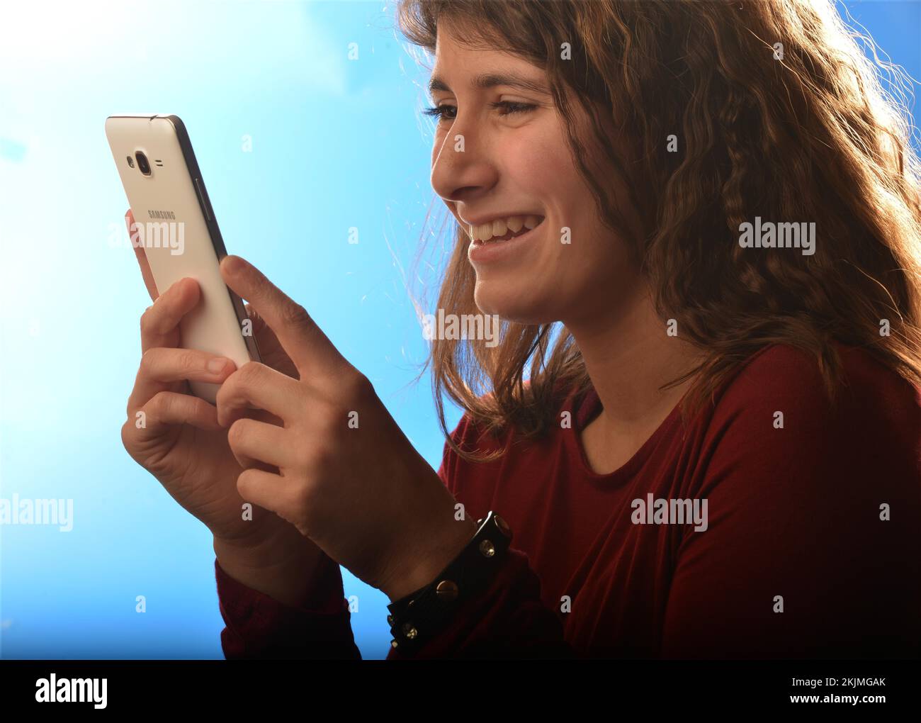 An 11-year-old girl stands as a model. With mobile phone, Germany ...