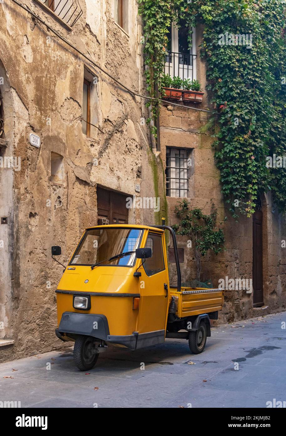 Three-wheeler in the streets of Pitigliano old town, Tuscany, Italy ...