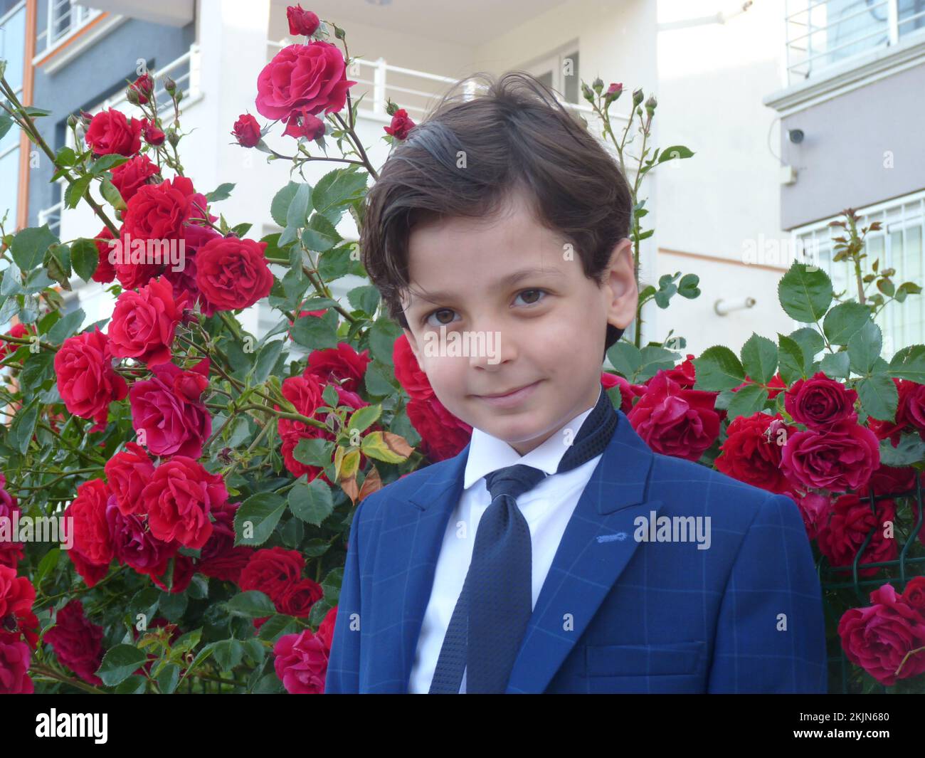 Young businessman outside with a stylish suit. Portrait of a young boy ...