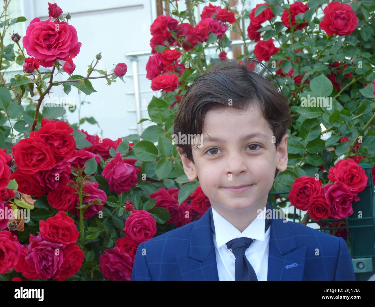 Young businessman outside with a stylish suit. Portrait of a young boy ...
