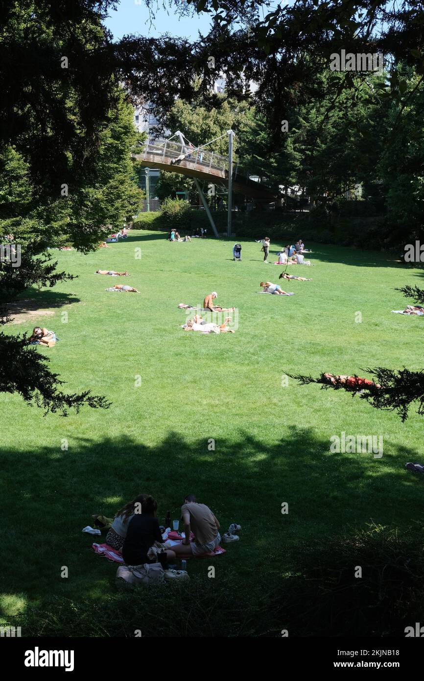 An aerial view people sitting and laying in a small park in Paris Stock ...
