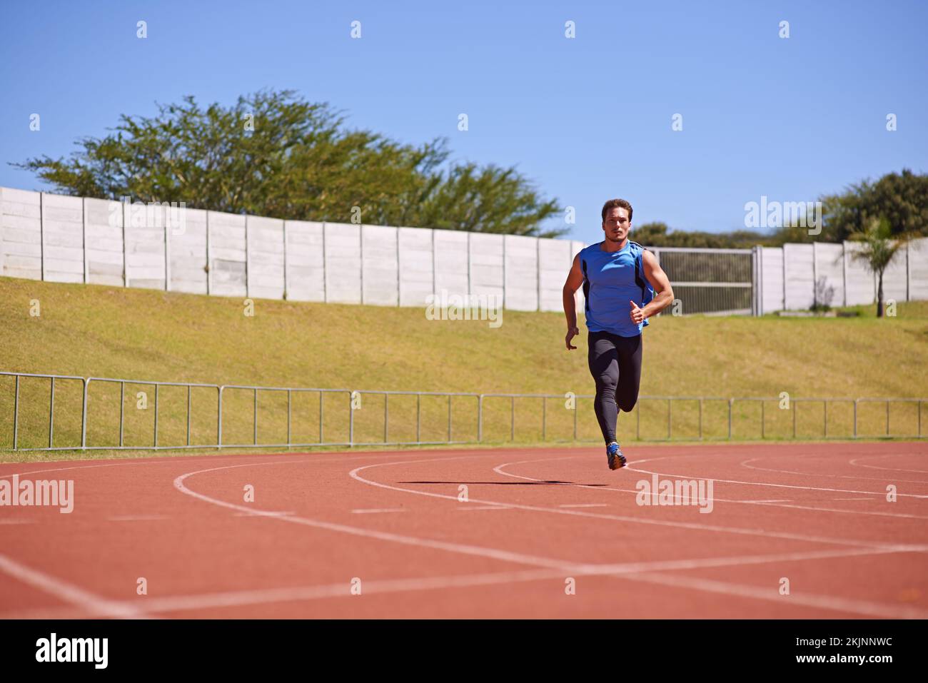 He belongs on the track. a young male athlete running on the track ...