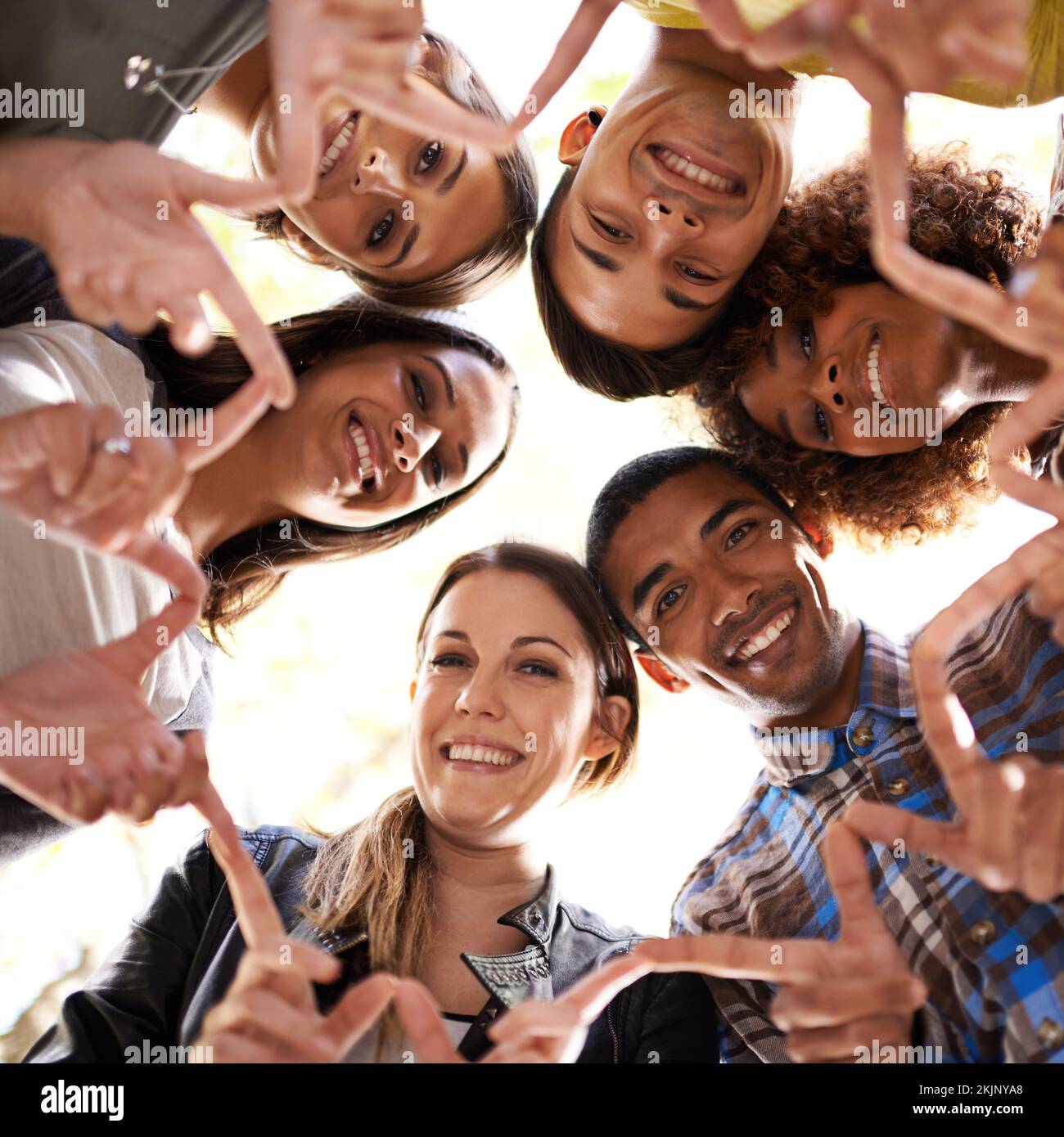 Peace yall. Low angle portrait of a group of young friends standing in ...