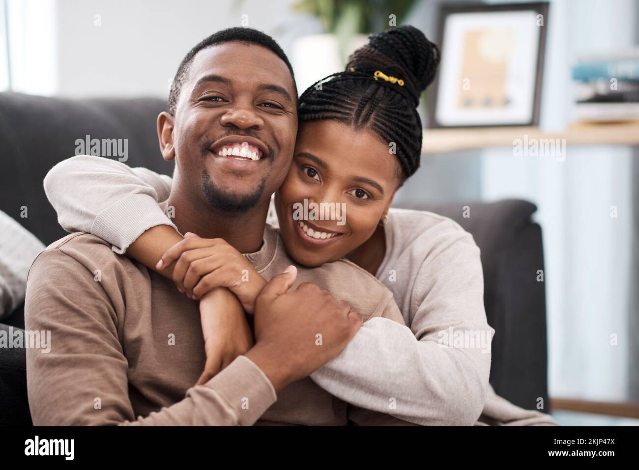 African couple hugging on sofa hi-res stock photography and images - Alamy