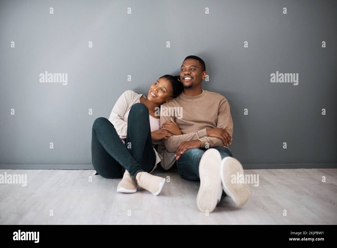 Apartment, love and couple on floor with wall background relax, rest ...