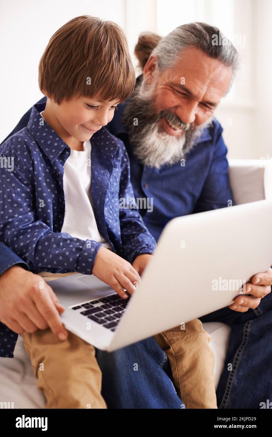 Helping grandpa with the laptop. a grandfather and grandson using a ...