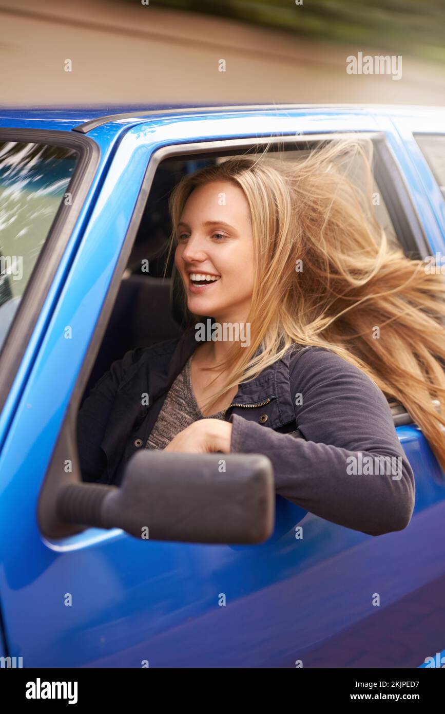 She Loves The Wind In Her Hair A Young Woman Feeling The Wind In Her Hair Through An Open Car