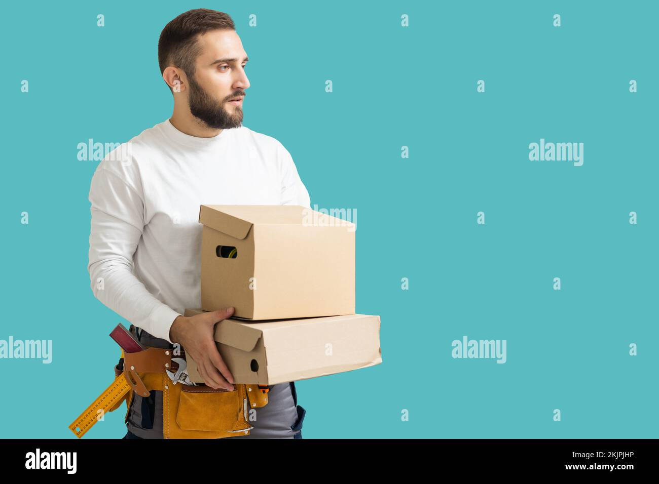 Portrait of a worker with tool and boxes Stock Photo - Alamy