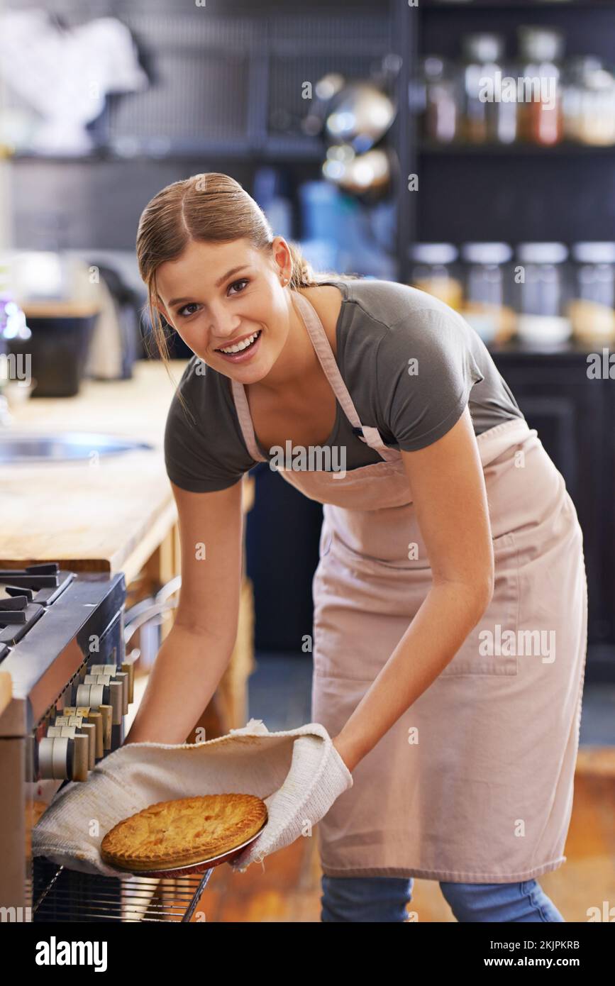 Baking is my speciality. Portrait of an attractive young woman taking ...